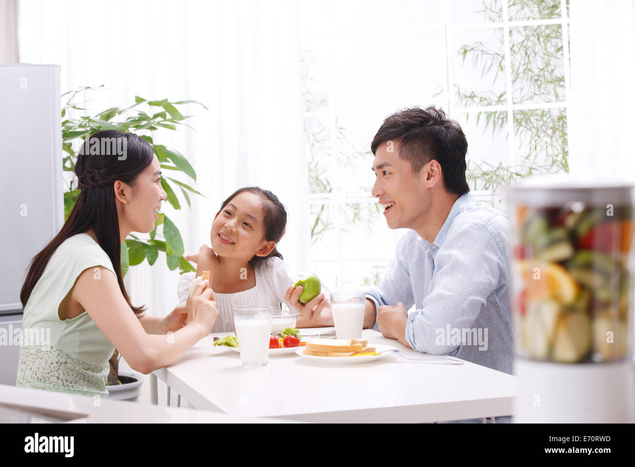 Family eating in kitchen Stock Photo - Alamy