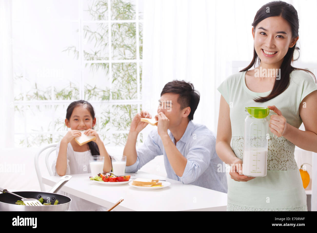 Family eating in kitchen Stock Photo - Alamy