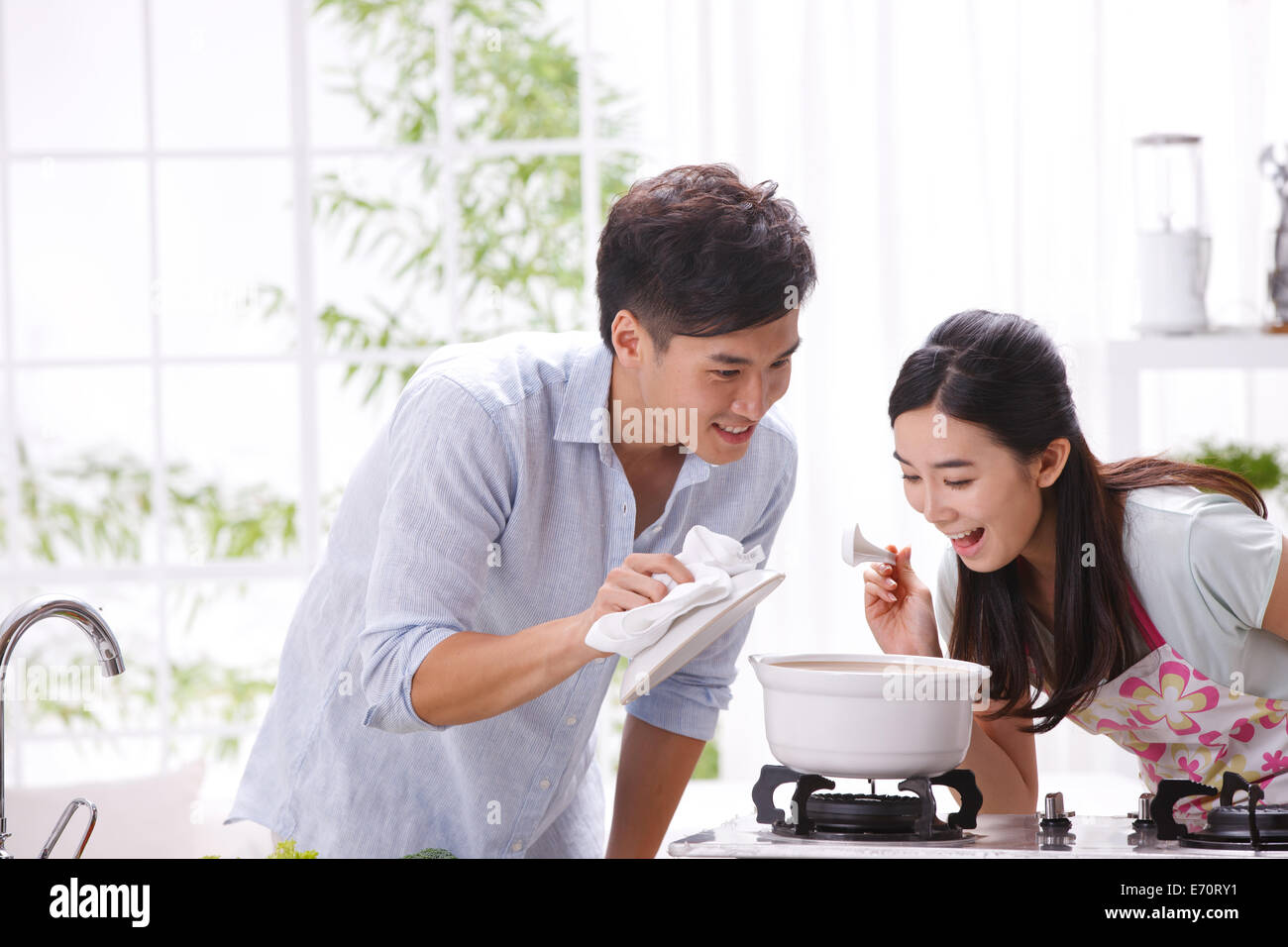 Young couple cooking in kitchen Stock Photo - Alamy