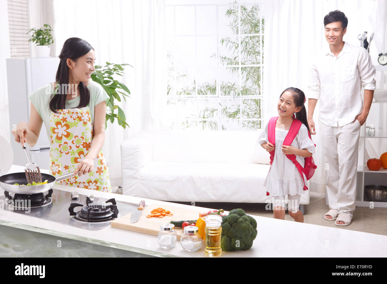 Family in kitchen Stock Photo - Alamy