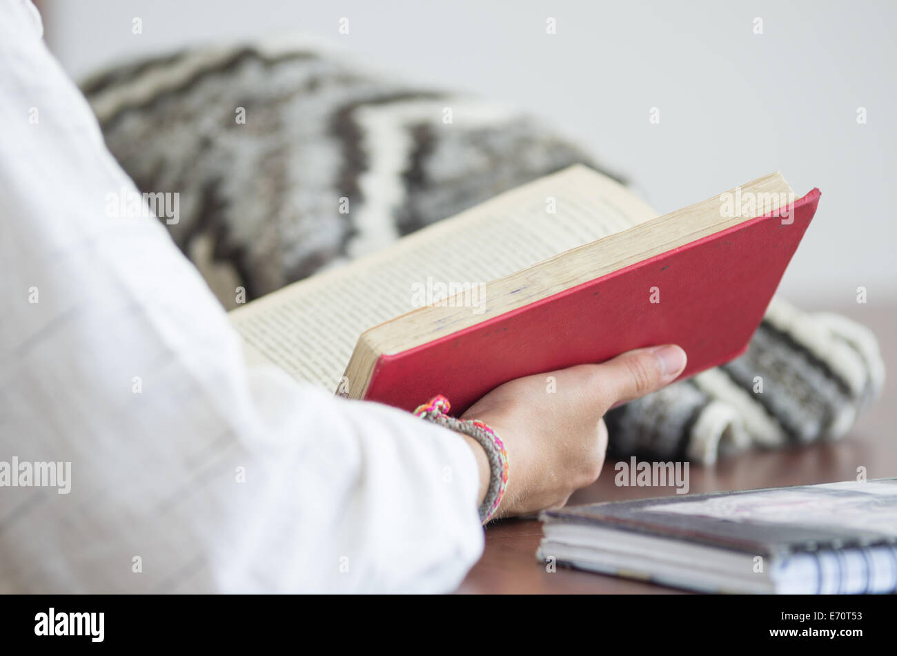 student reading a book in library Stock Photo - Alamy