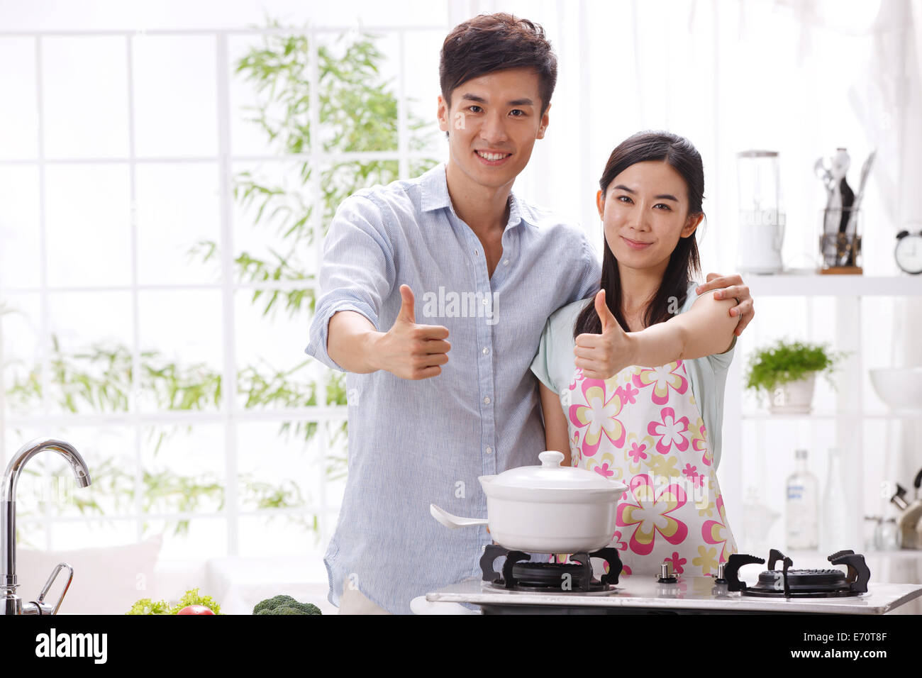 Young couple cooking in kitchen Stock Photo - Alamy