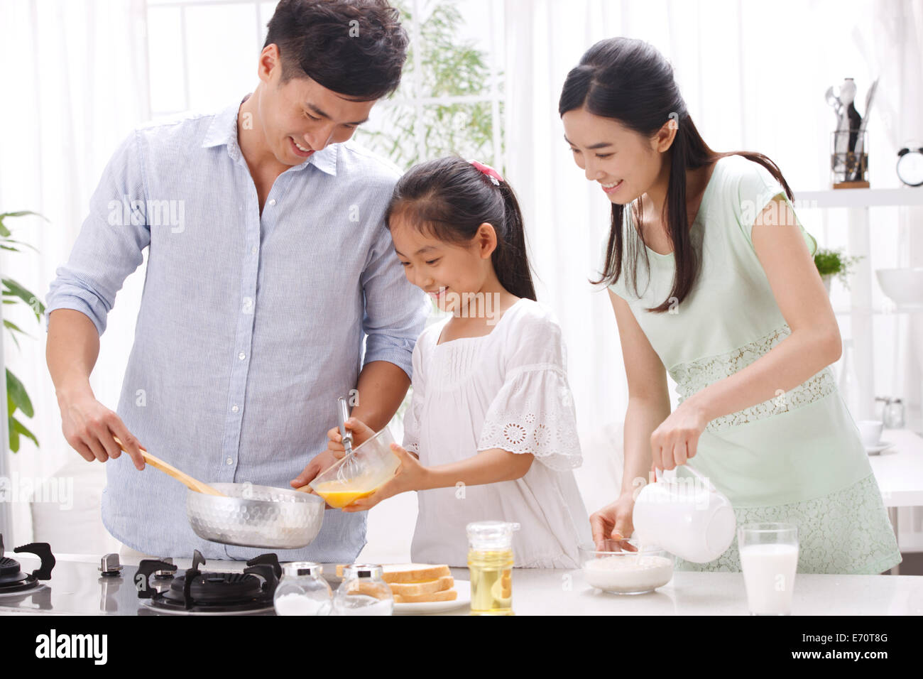 Family cooking in kitchen Stock Photo - Alamy