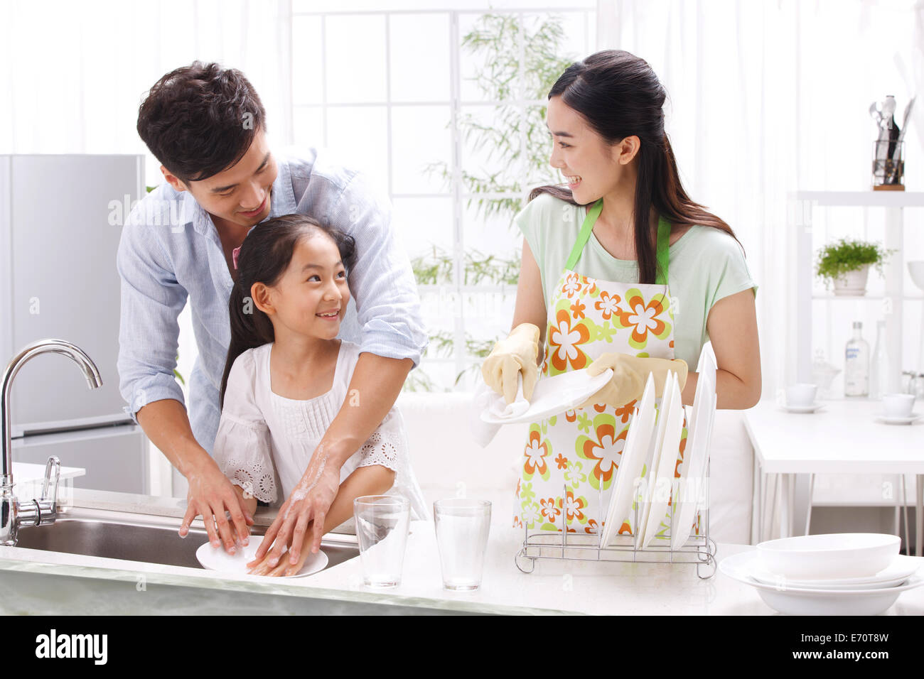 Family washing dishes in kitchen Stock Photo - Alamy