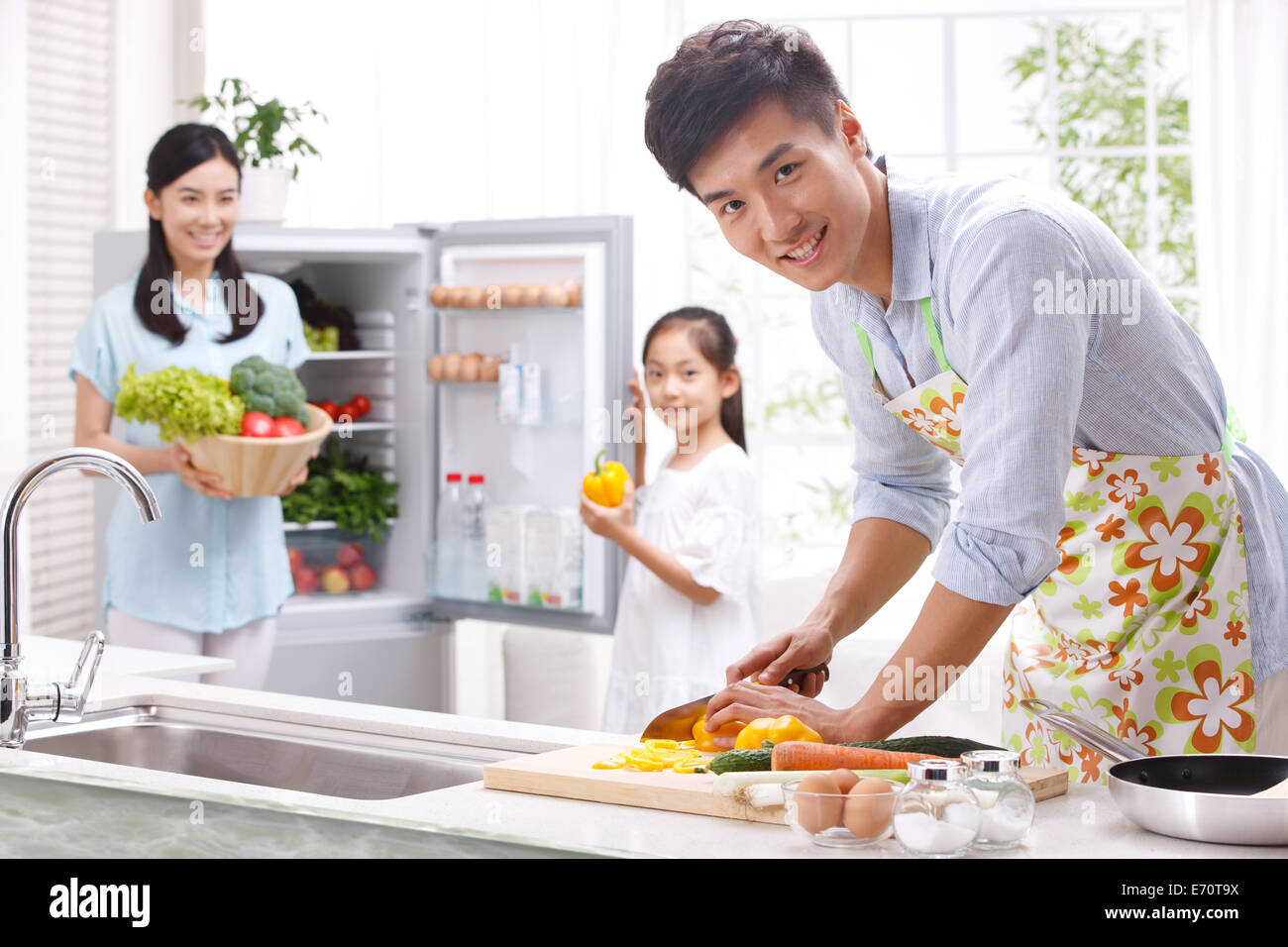 Family cooking in kitchen Stock Photo - Alamy