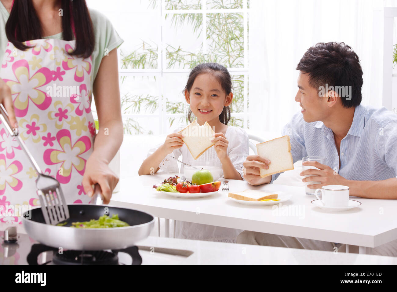 Family eating in kitchen Stock Photo - Alamy