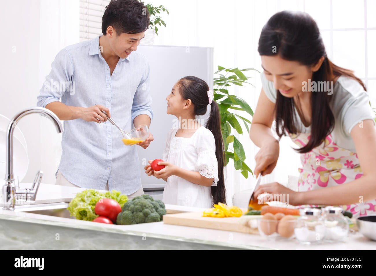Family cooking in kitchen Stock Photo - Alamy