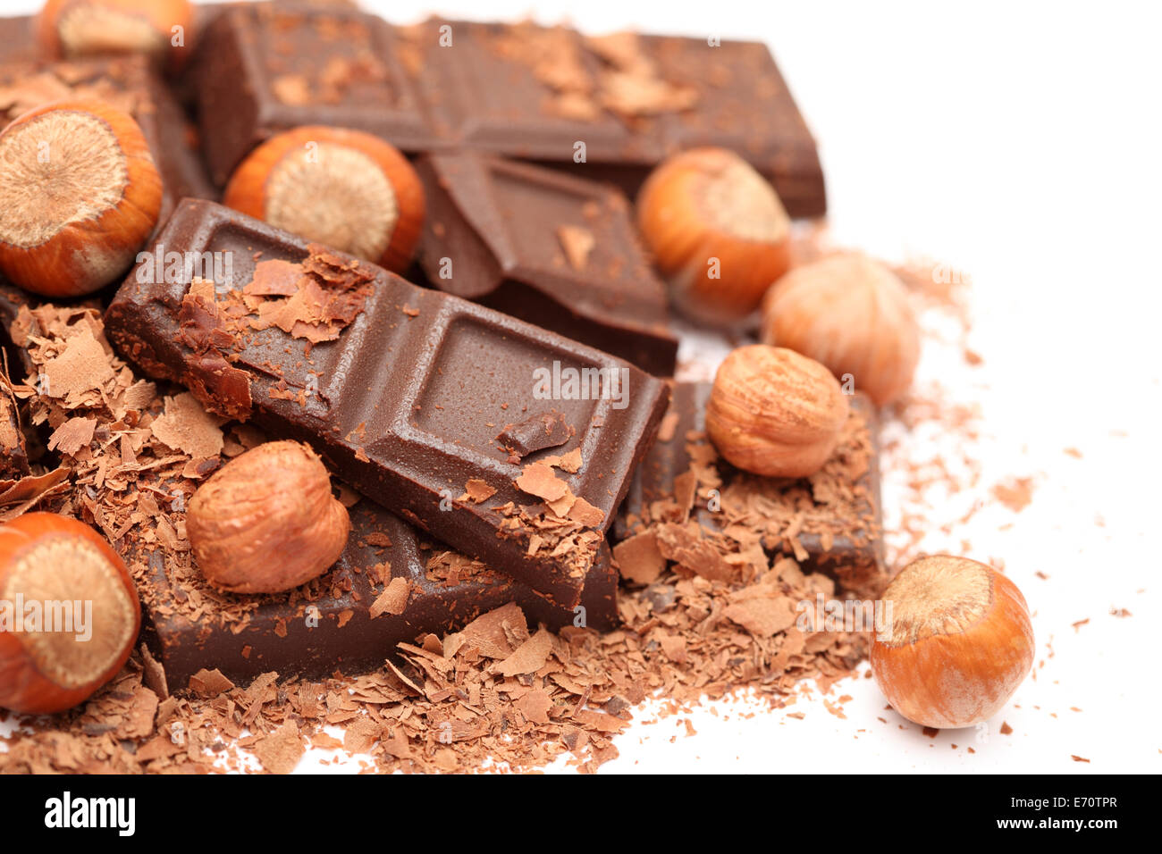 Chocolate and hazelnuts on white background. Closeup Stock Photo - Alamy