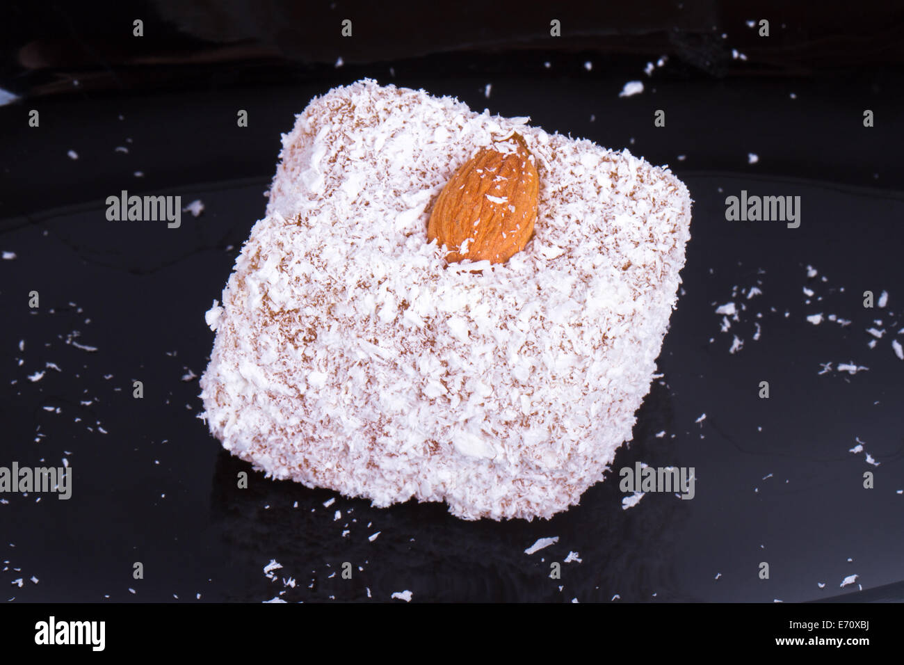 Single Turkish delight in black bowl, isolated on white background ...
