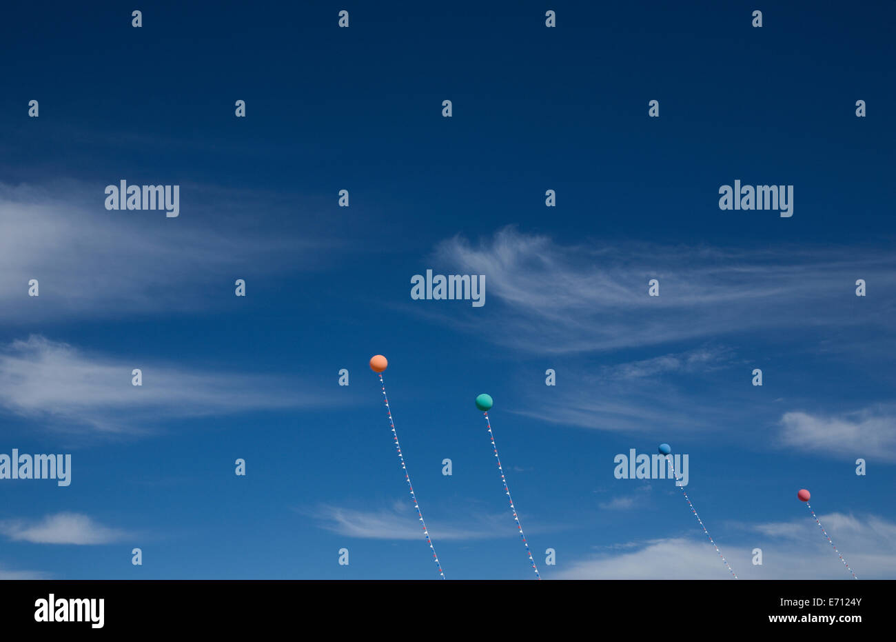 Four balls with string attached floating in mid air Stock Photo - Alamy