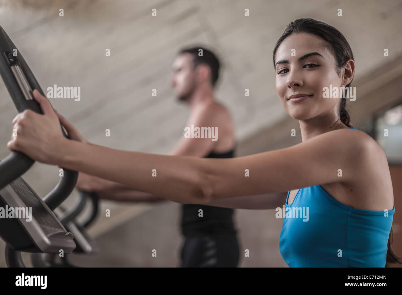 Woman using gym equipment Stock Photo - Alamy