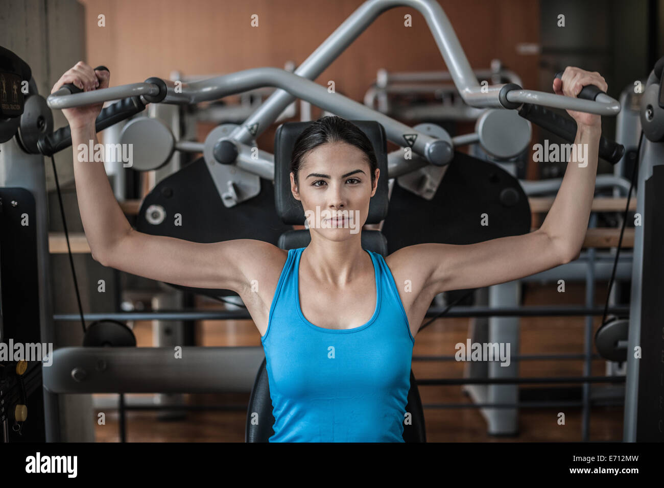 Young woman using weight equipment Stock Photo - Alamy