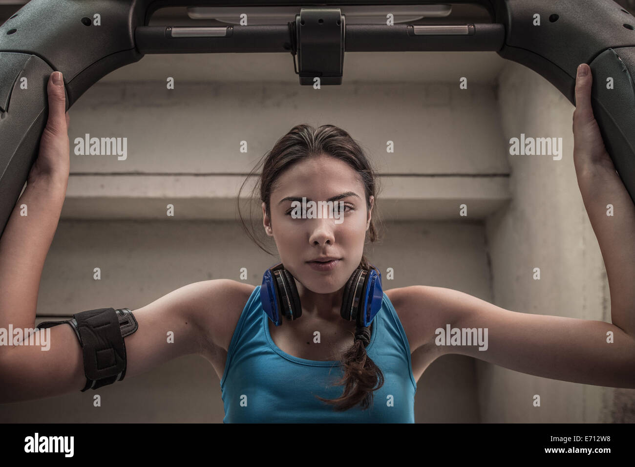 Young woman using gym equipment, portrait Stock Photo - Alamy