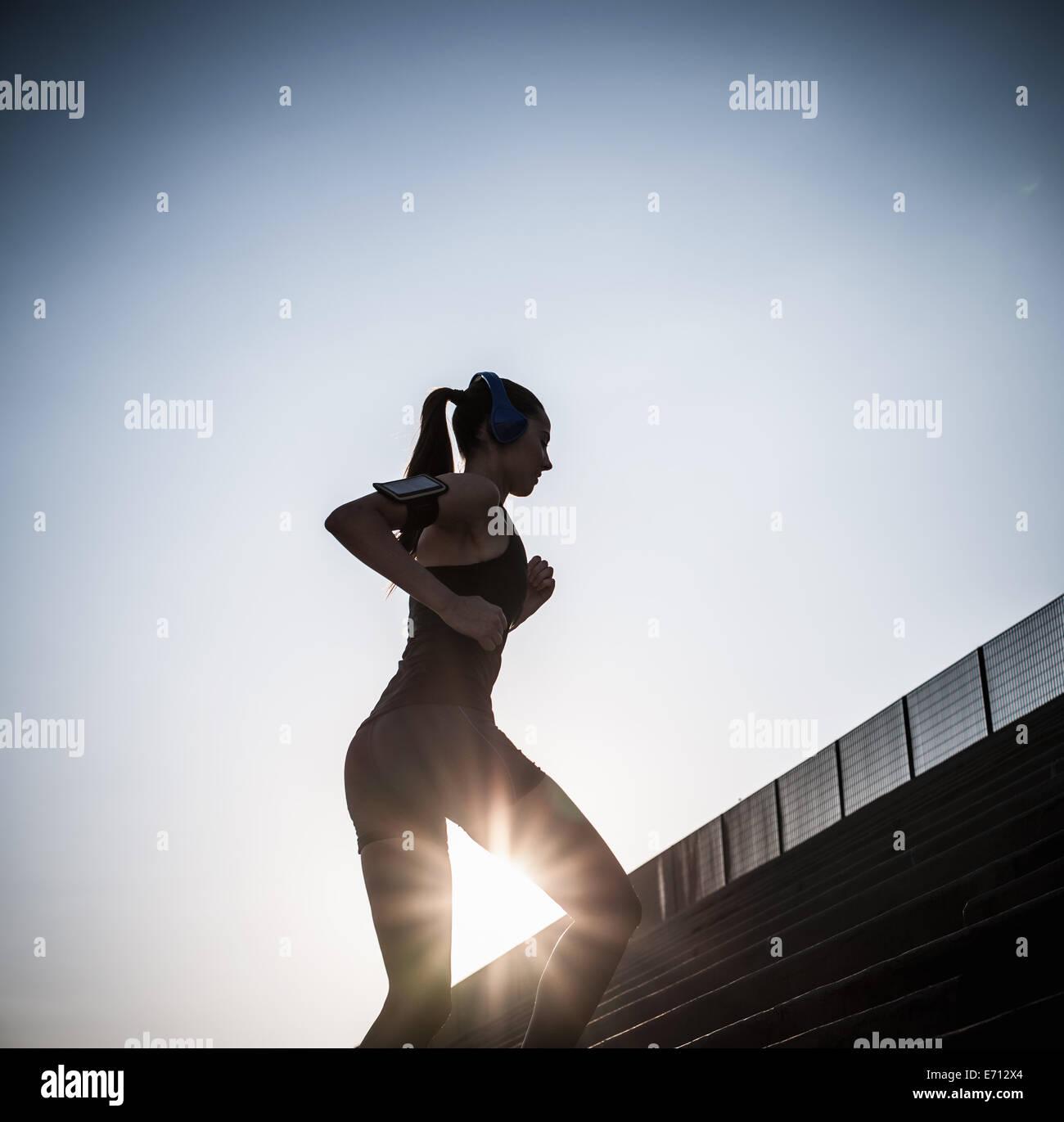 Young woman running up steps Stock Photo - Alamy