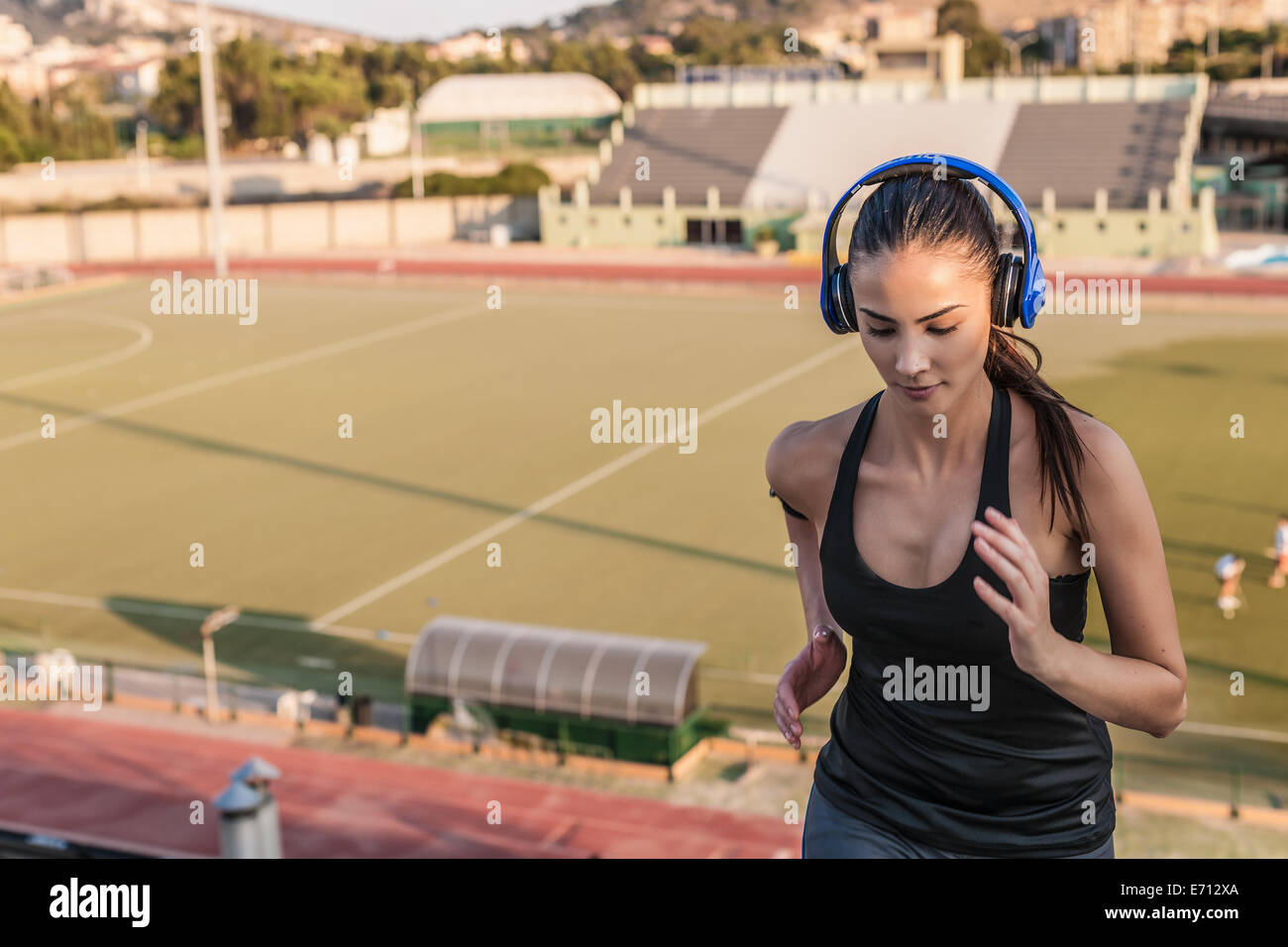 Woman running with headphones hi-res stock photography and images - Alamy