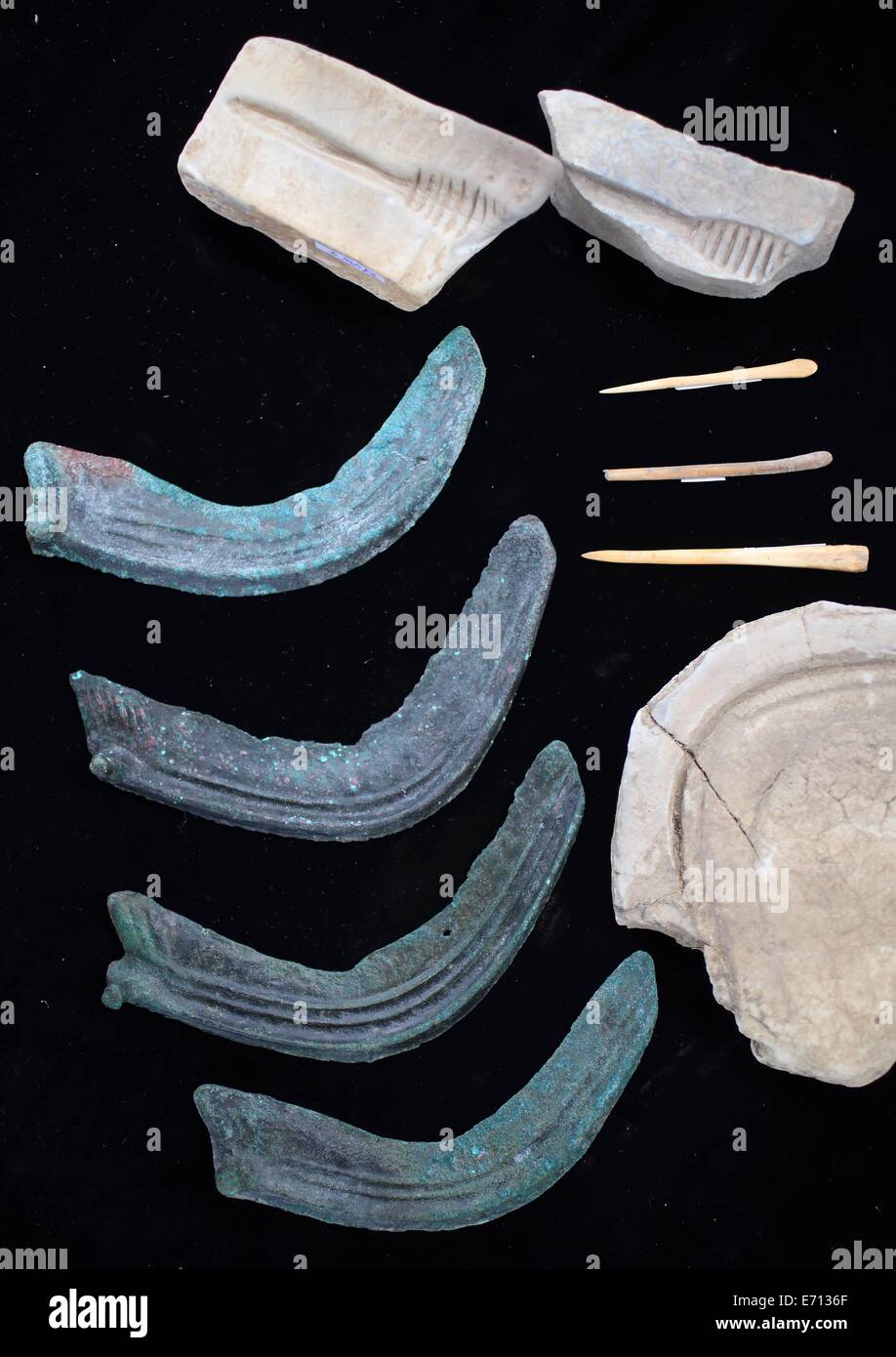 Molds and four sickles are presented at an excavation area of the State ...