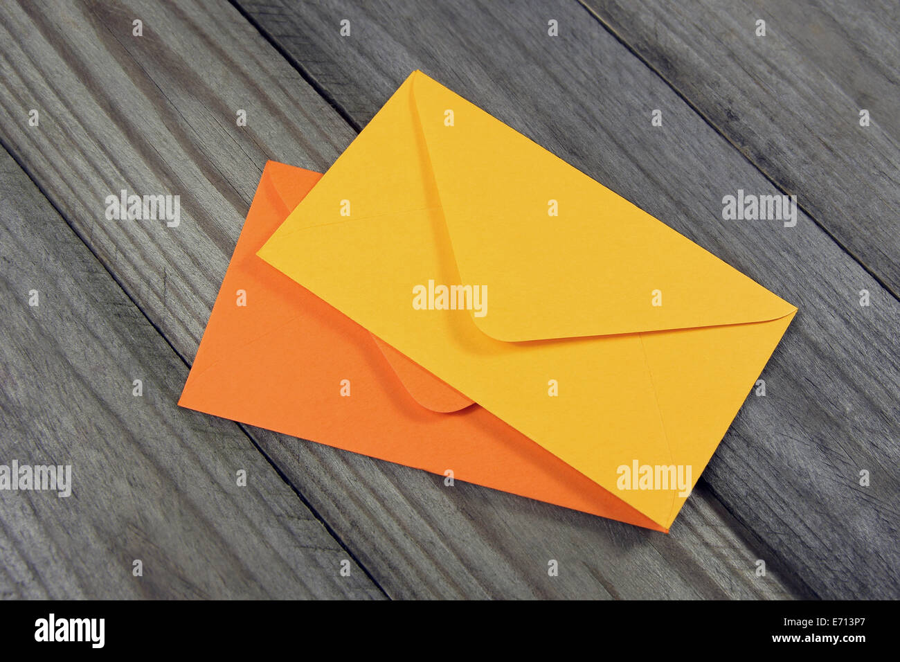 yellow and orange envelopes on wooden background Stock Photo - Alamy