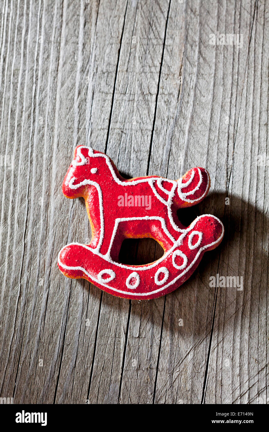 Red-white gingerbread rocking horse on grey wood Stock Photo - Alamy