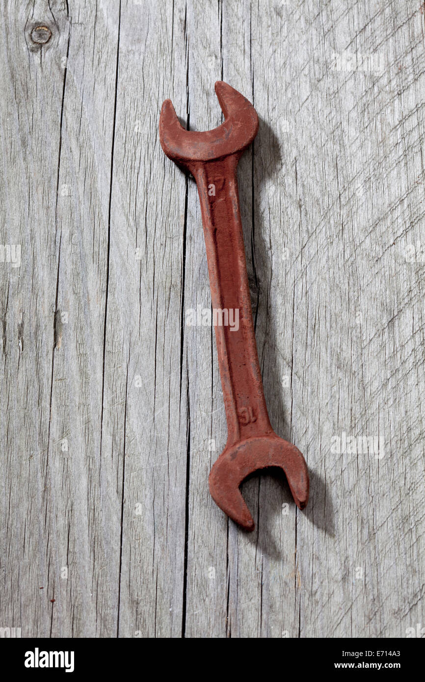 Screw wrench made of chocolate lying on grey wood Stock Photo - Alamy
