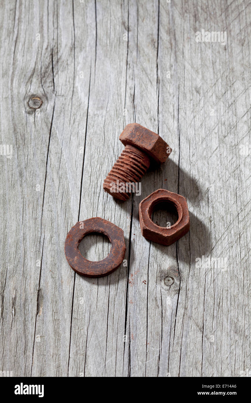 Screw, female screw and cog made of chocolate lying on grey wood Stock ...
