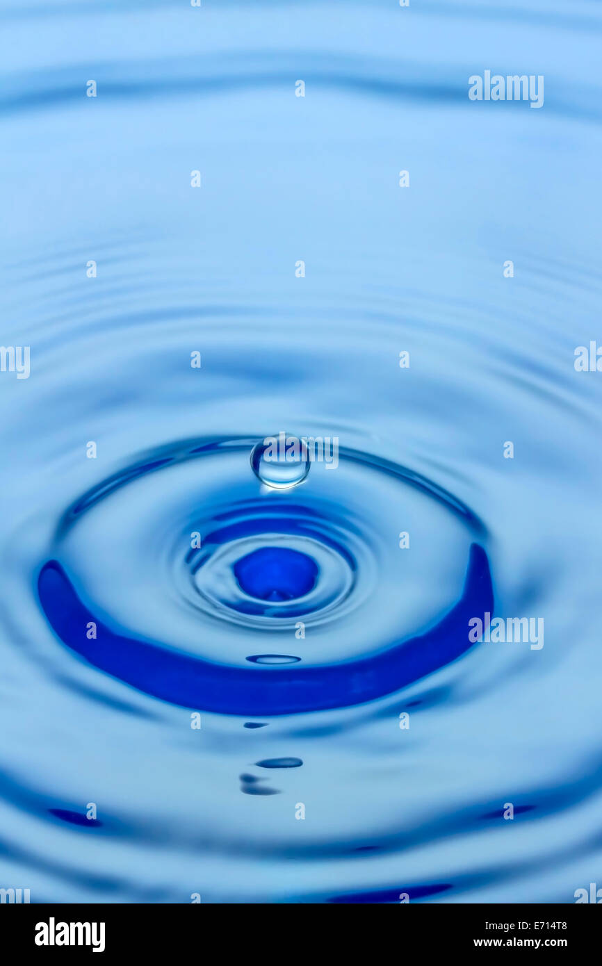 Waterdrop splashing on water surface Stock Photo - Alamy