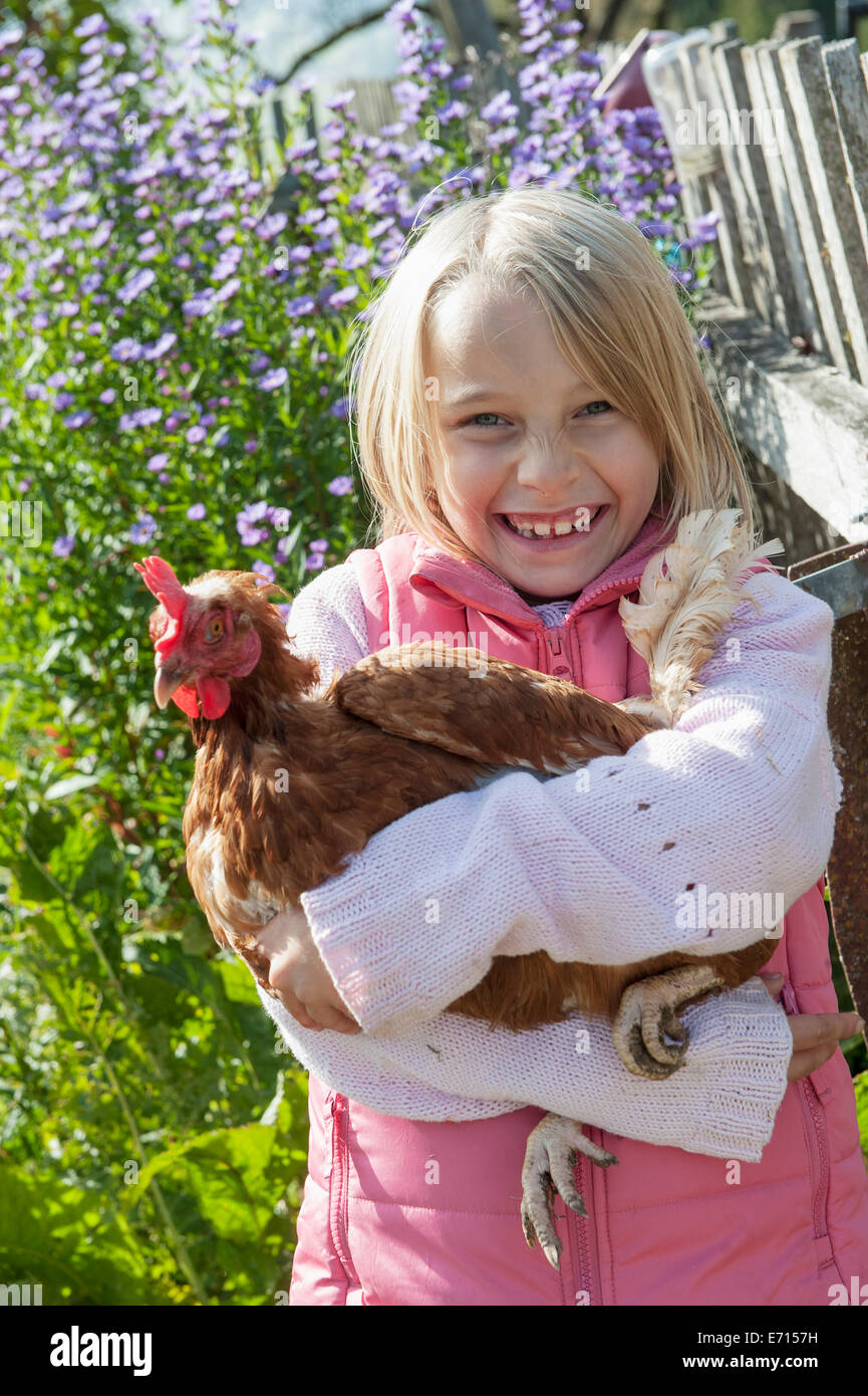 Happy girl hugging hen Stock Photo - Alamy