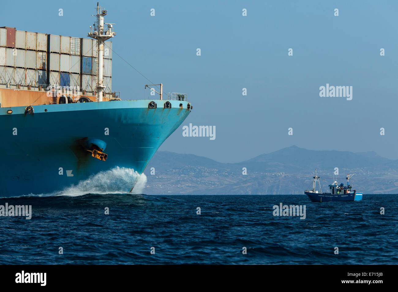 Spain, Andalusia, Tarifa, Container ship and fishing boat Stock Photo ...