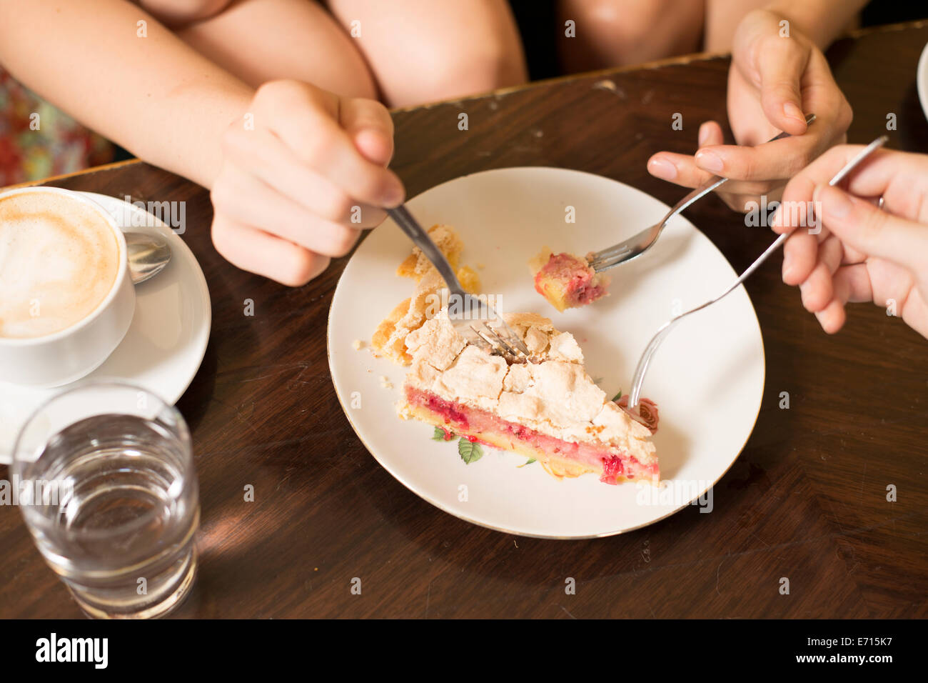 Three people sharing piece of cake, partial view Stock Photo - Alamy