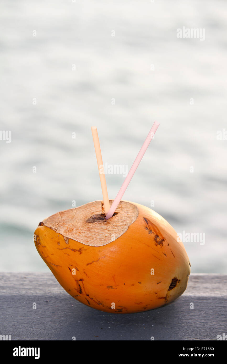 Coconut with straws Stock Photo - Alamy