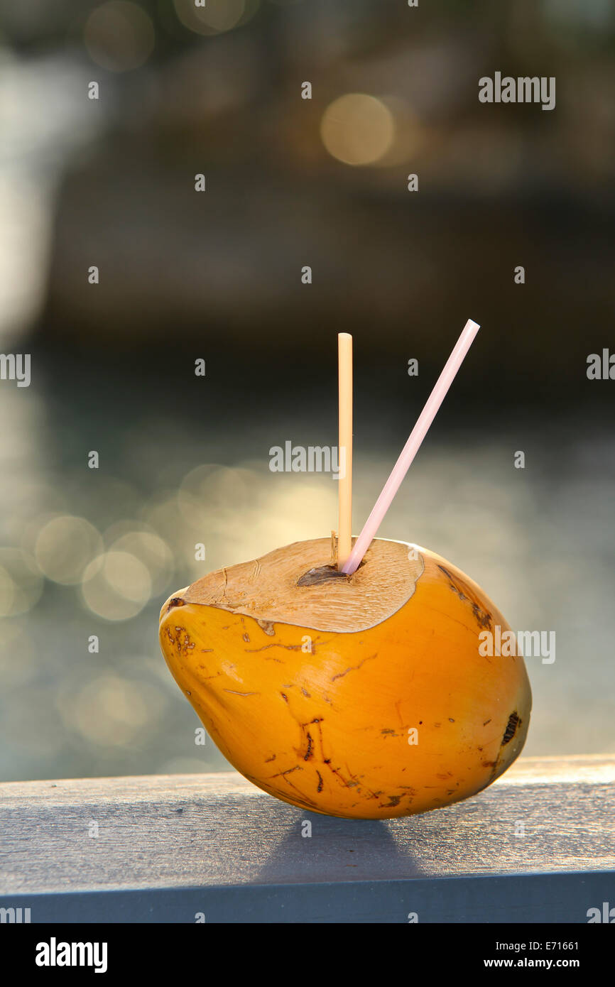 Coconut with straws Stock Photo - Alamy
