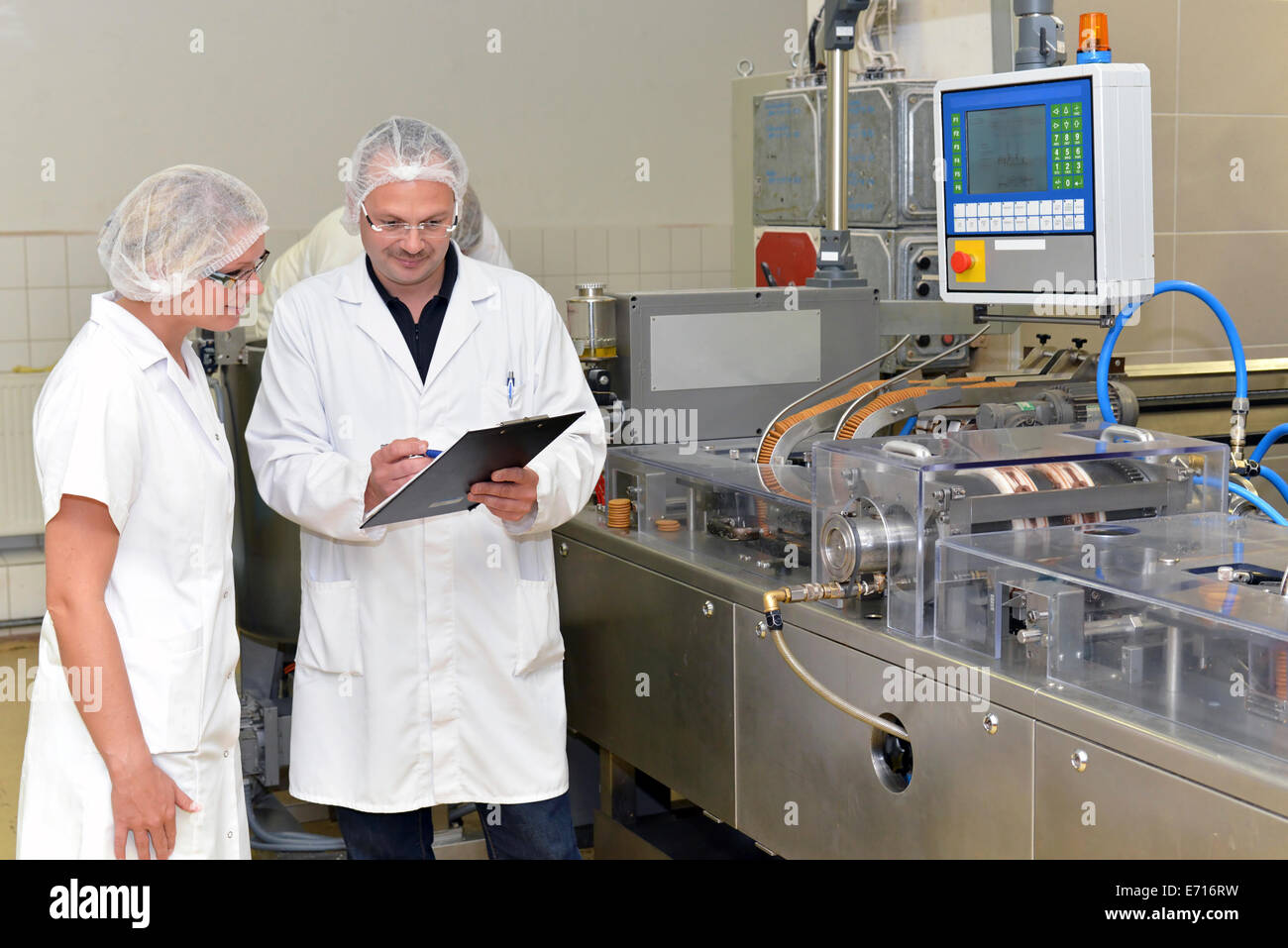 Workers talking in biscuit factory hi-res stock photography and images ...