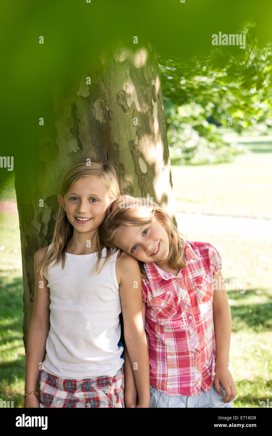 Germany, Berlin, Two sisters in park Stock Photo - Alamy