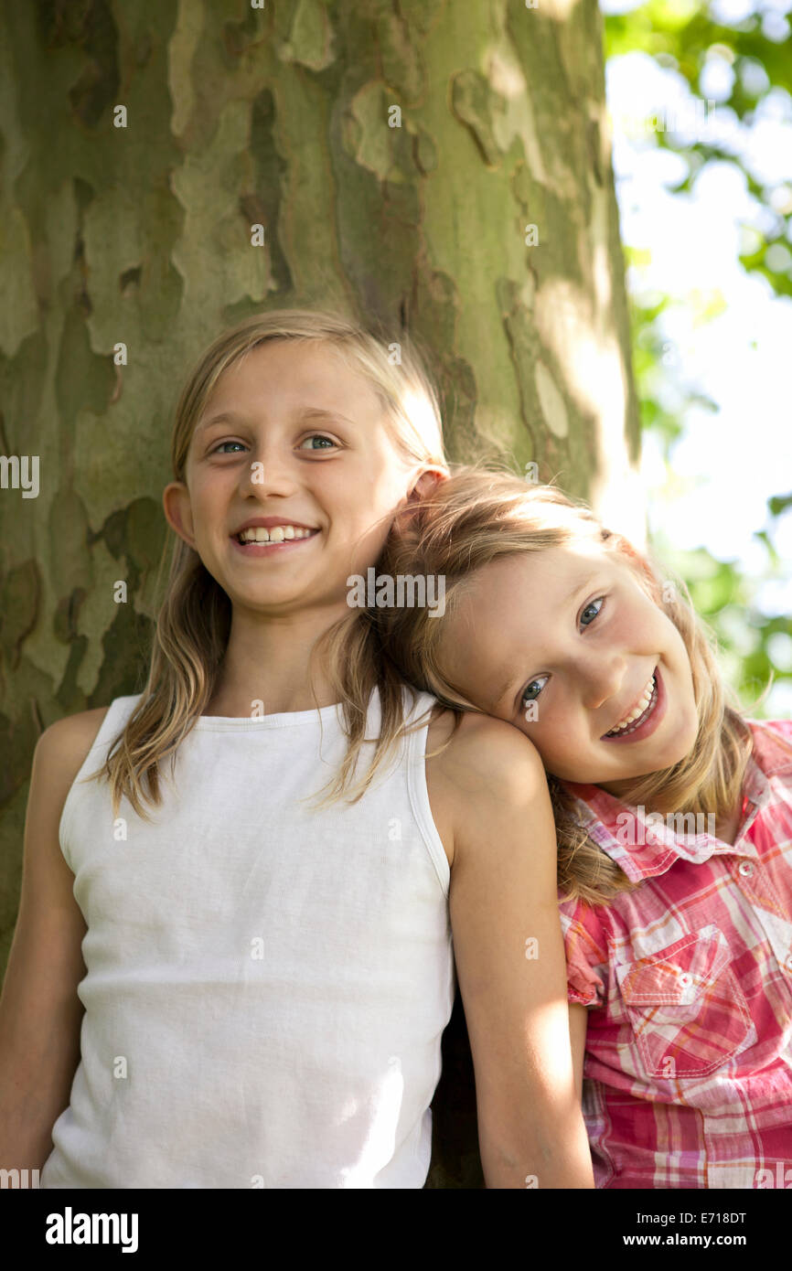 Germany, Berlin, Two sisters in park Stock Photo - Alamy