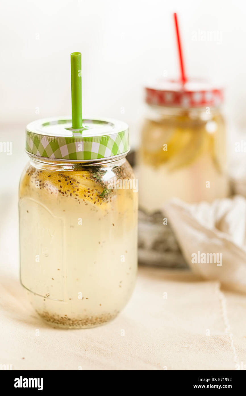 Two screw-top jar of chia fresca, mexican lemonade with chia seeds ...