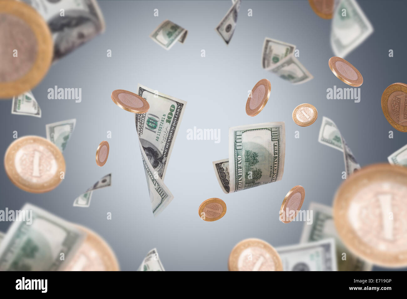 Group of one hundred dollar banknotes and coins flying on dark ...