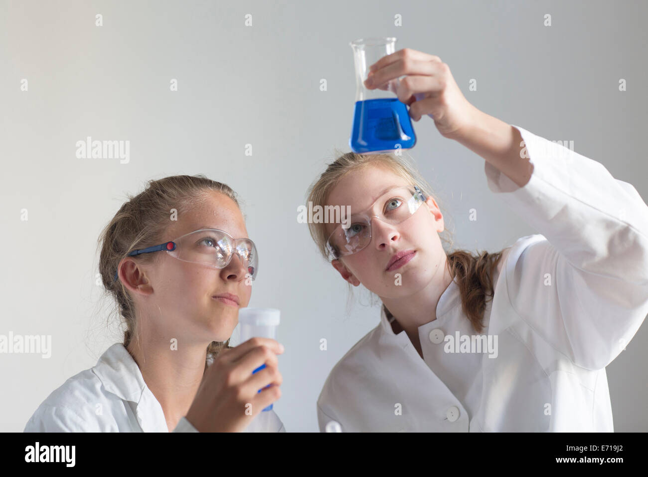 Two teenage girls having a chemical experiment Stock Photo - Alamy