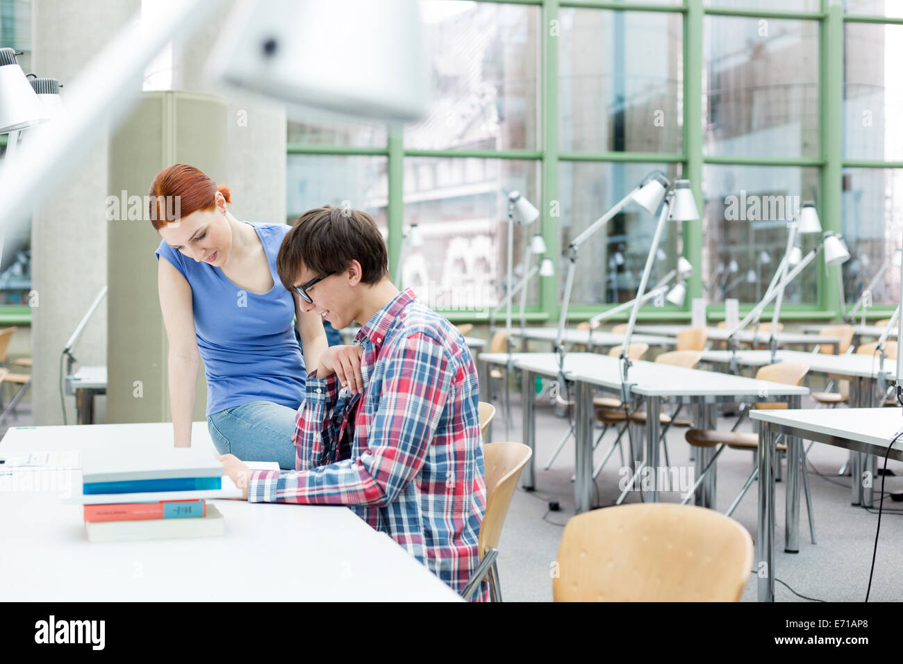 Two students learning in a university library Stock Photo - Alamy