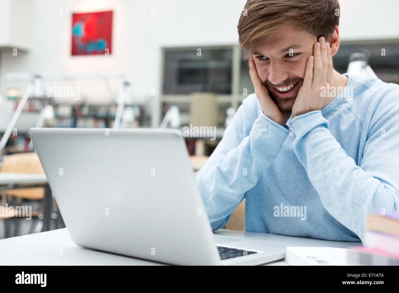Student using laptop in a university library Stock Photo - Alamy