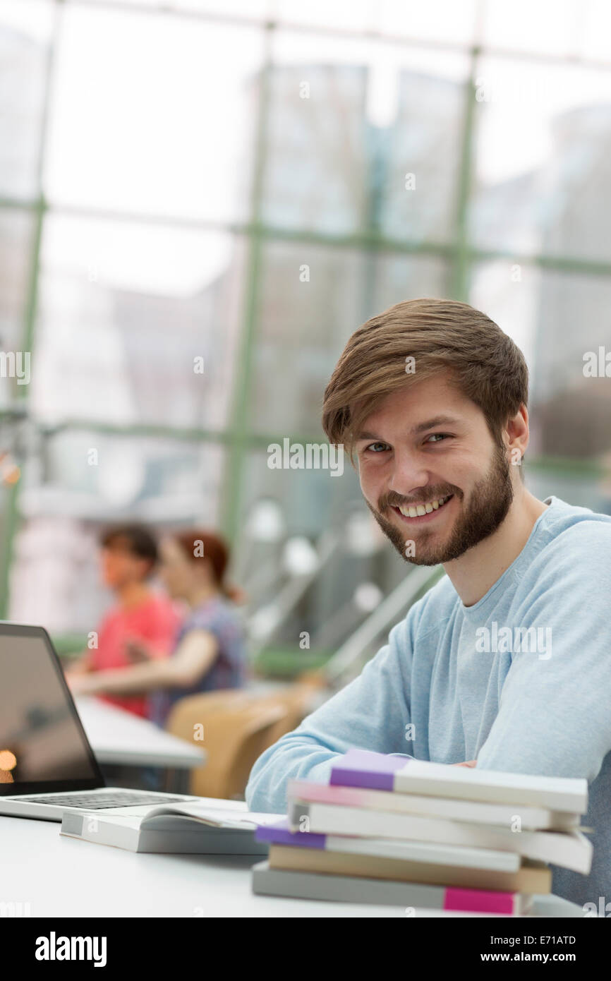 Portrait of student learning in a university library Stock Photo - Alamy