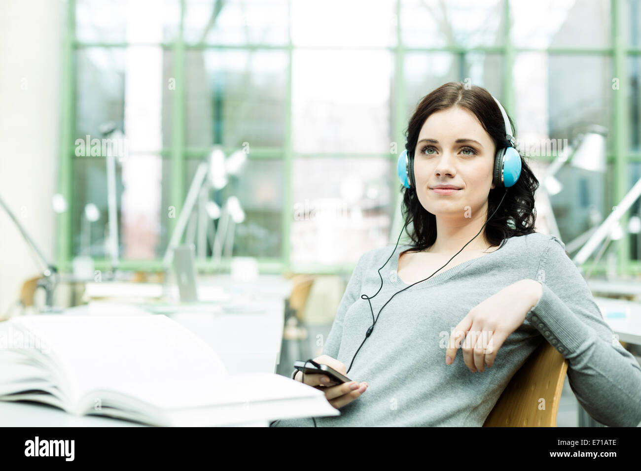 Student with headphones in a university library Stock Photo - Alamy