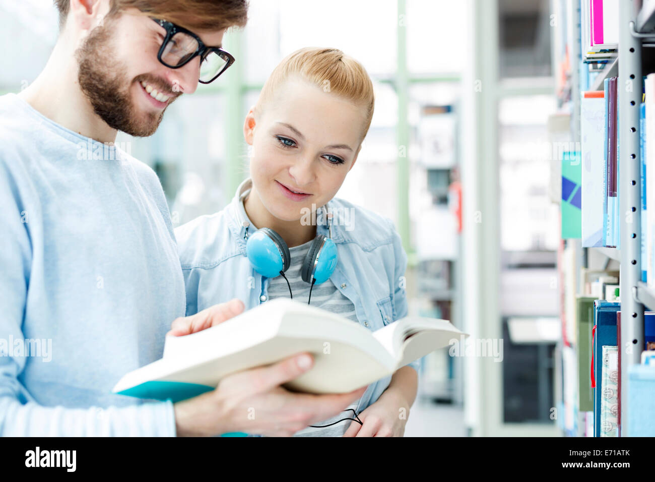 Two students reading book in a university library Stock Photo - Alamy