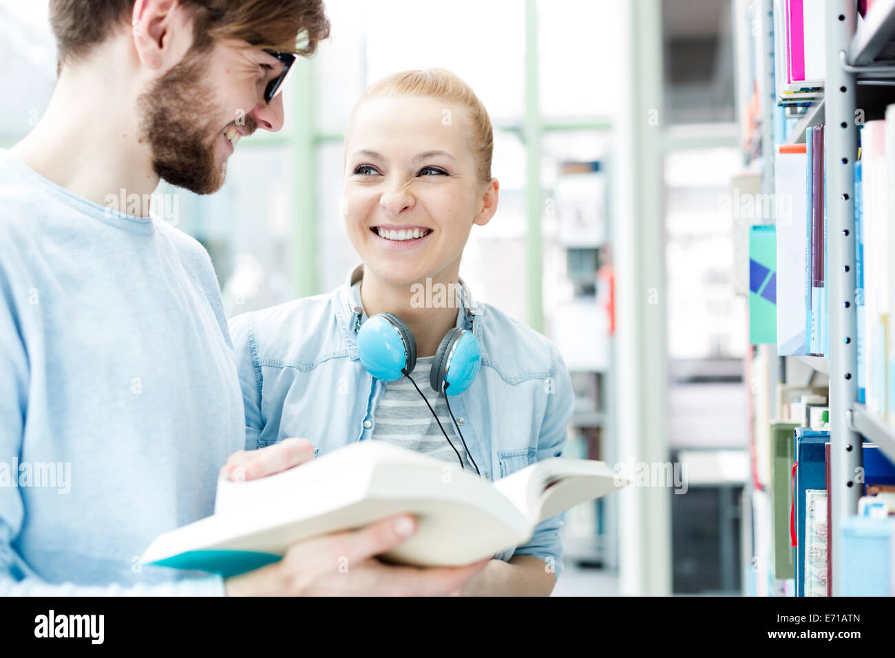 Two students reading book in a university library Stock Photo - Alamy