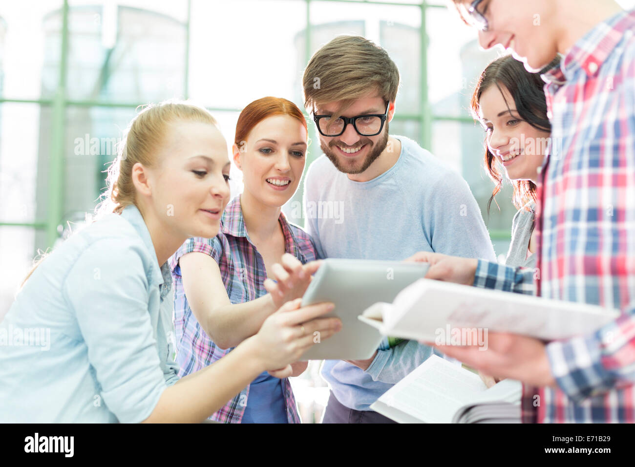 Students in a university library using digital tablet Stock Photo - Alamy
