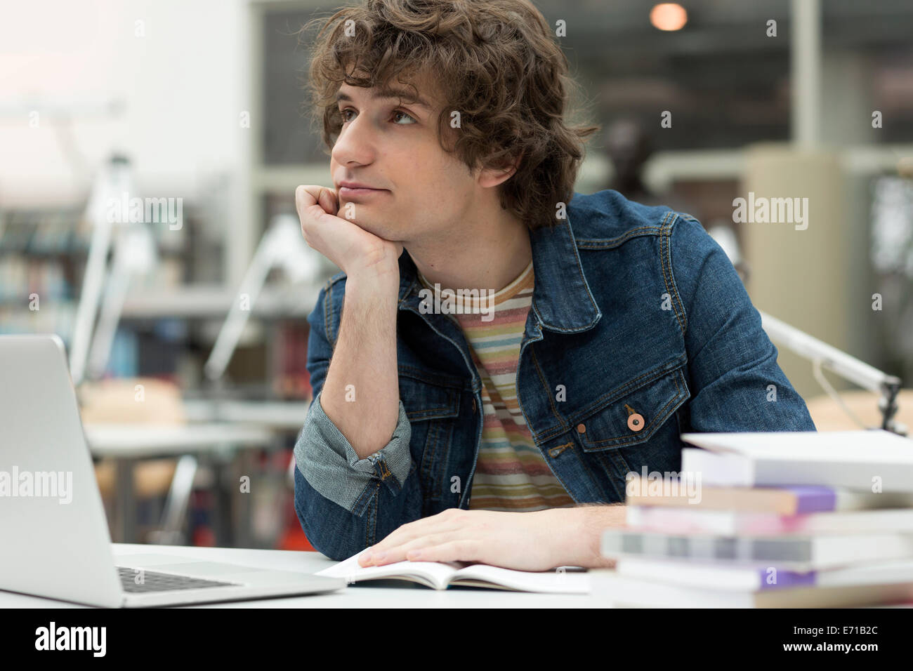 Distracted student in a university library Stock Photo - Alamy