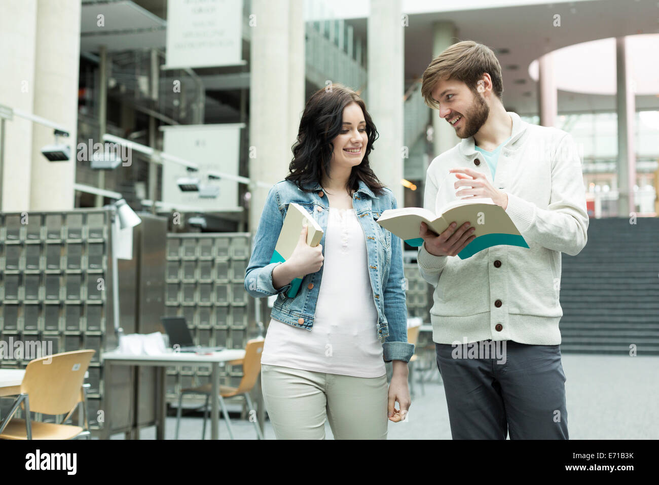 Two students reading book in a university library Stock Photo - Alamy