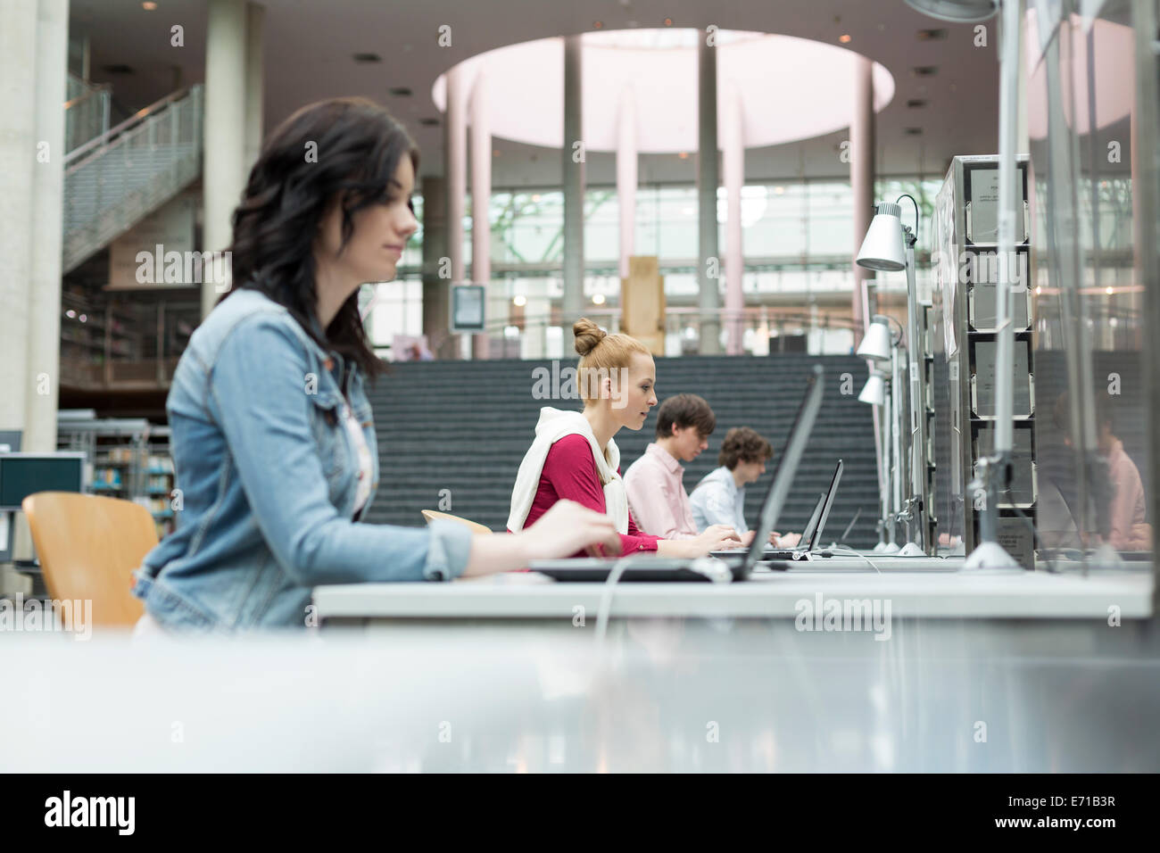 Students using laptops in a university library Stock Photo - Alamy