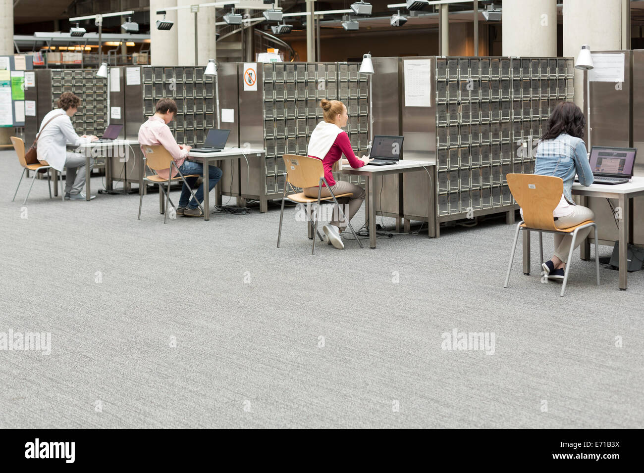 Students in a university library using laptops Stock Photo - Alamy