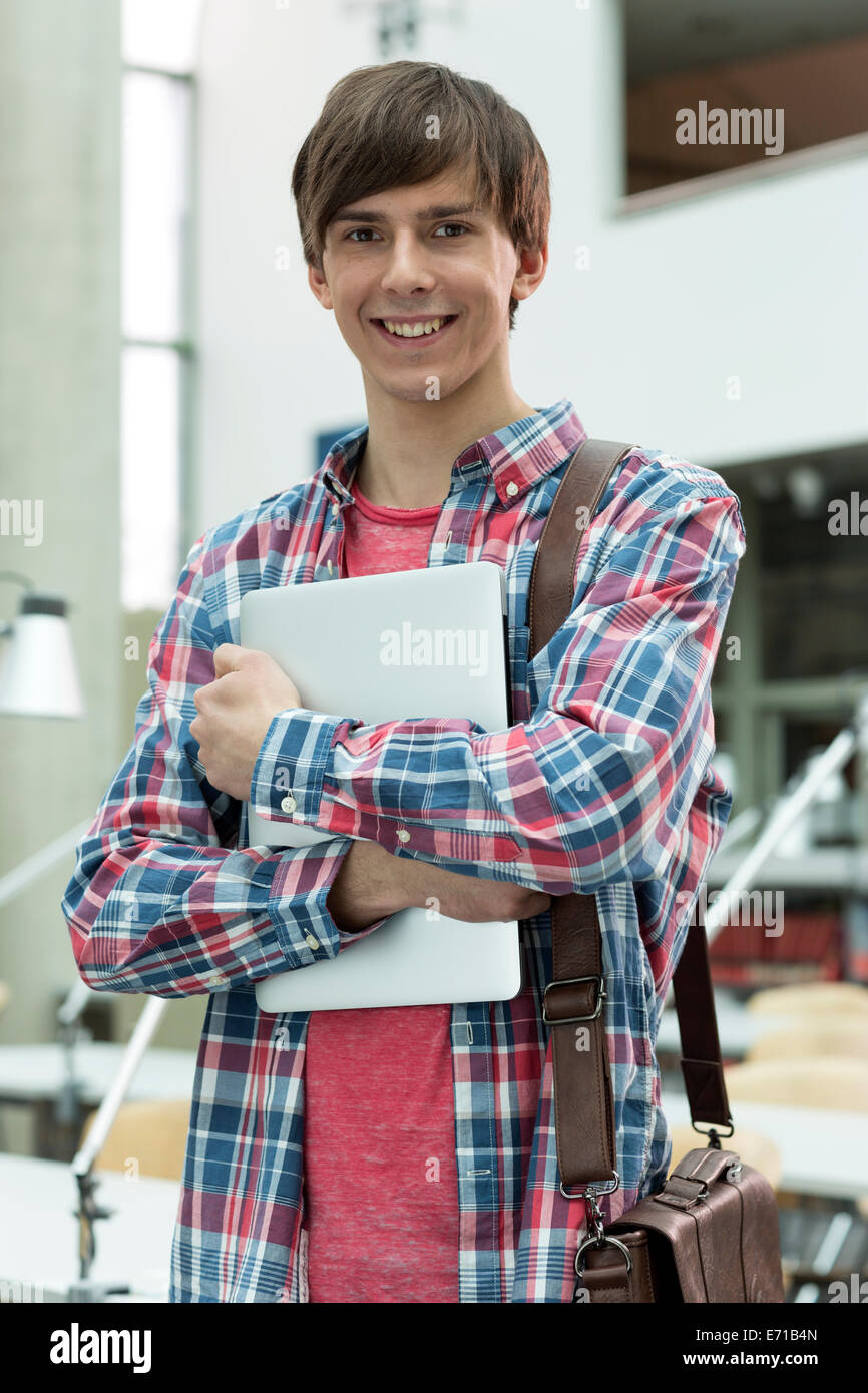Portrait of student in a university library Stock Photo - Alamy