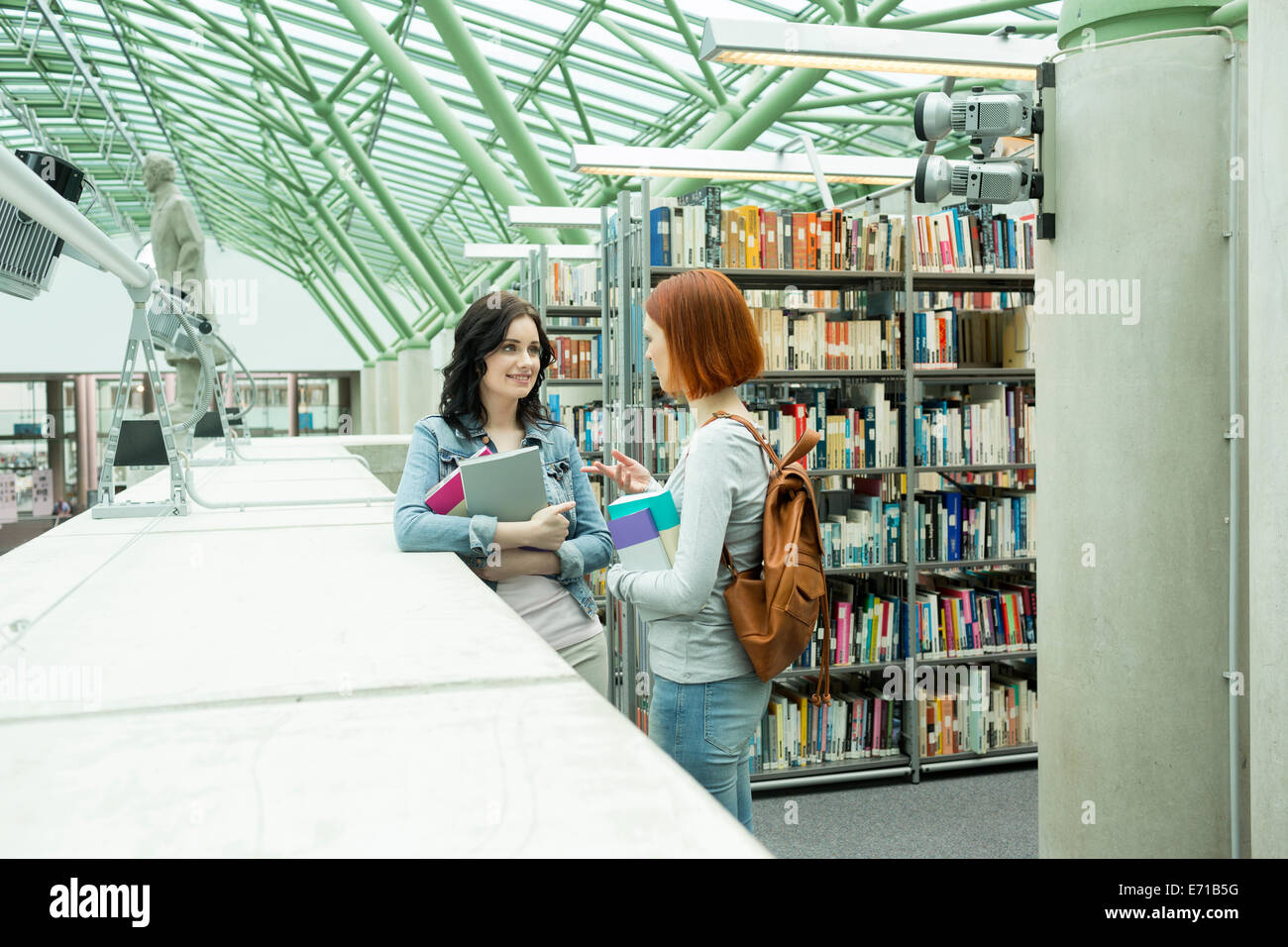 Two students in a university library Stock Photo - Alamy