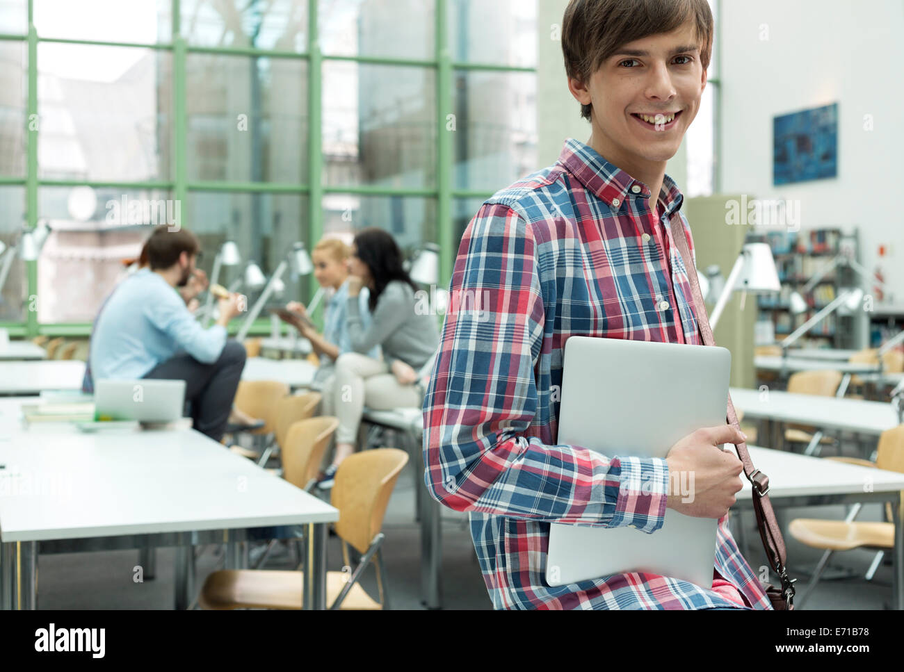 Portrait of student in a university library Stock Photo - Alamy